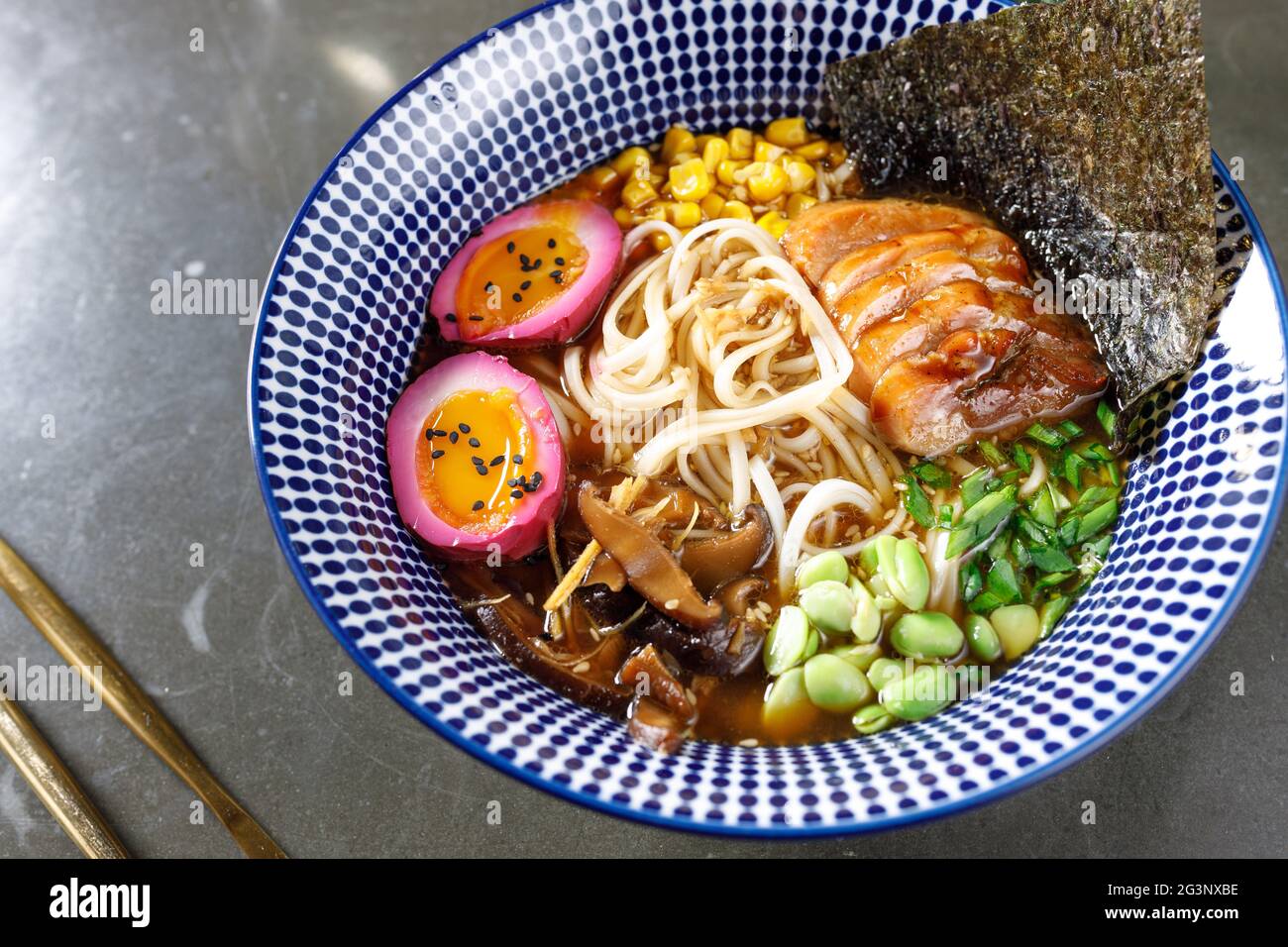 miso soup with eel mushrooms eggs vegetables and udon noodles Stock ...