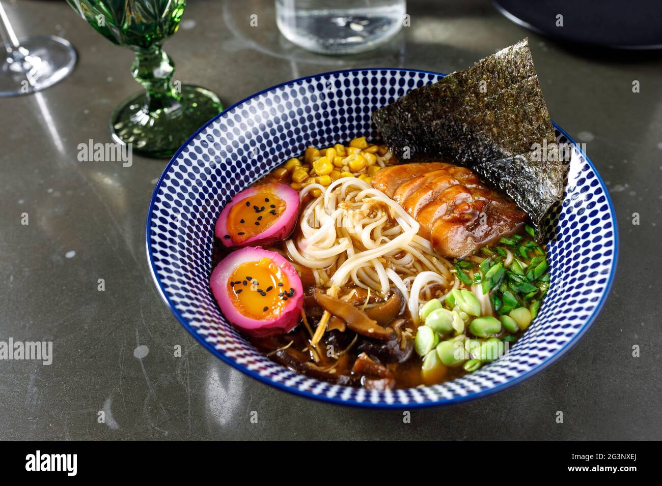 miso soup with eel mushrooms eggs vegetables and udon noodles Stock ...