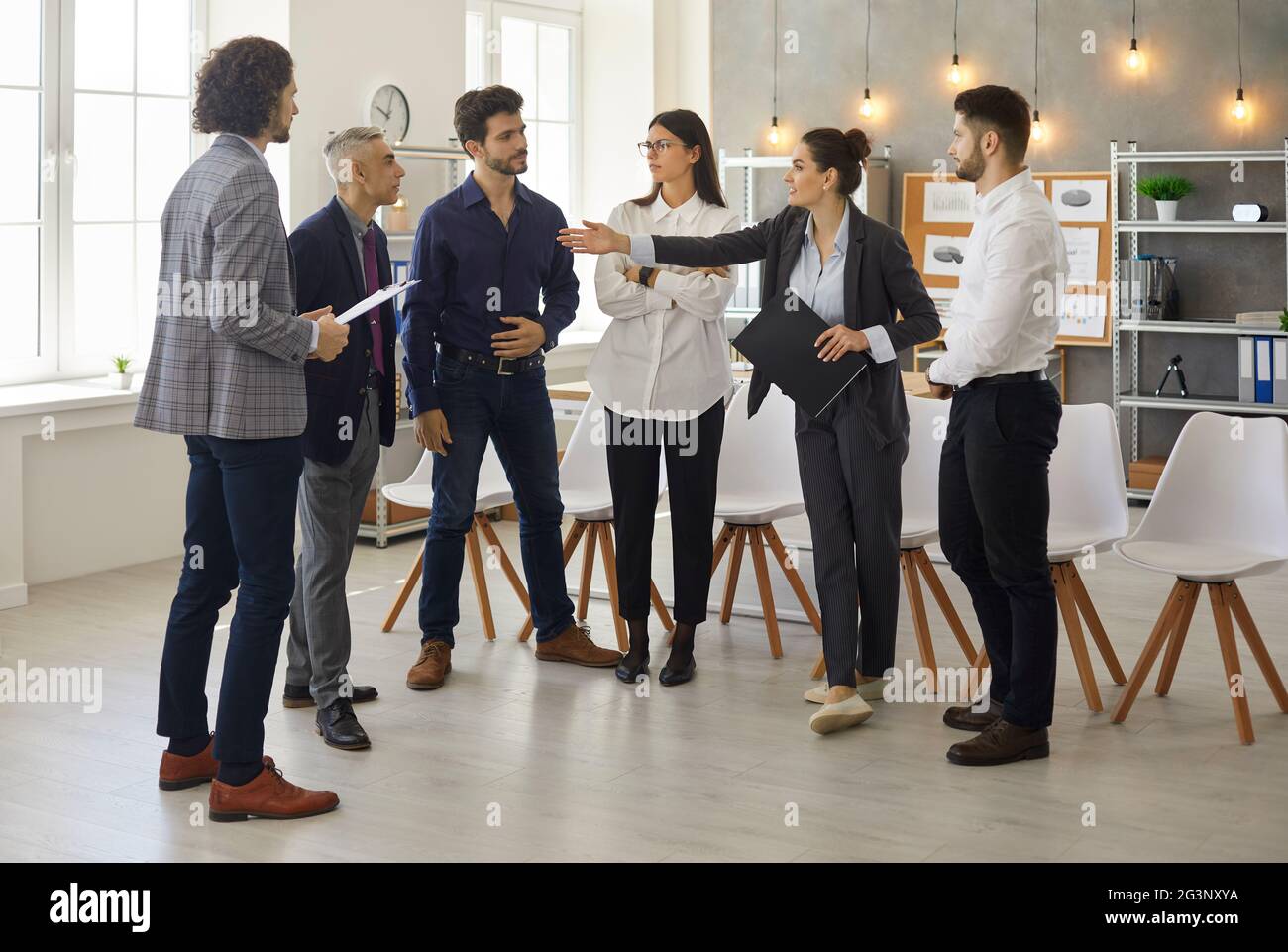 Leader and business team members talking standing in semicircle in ...