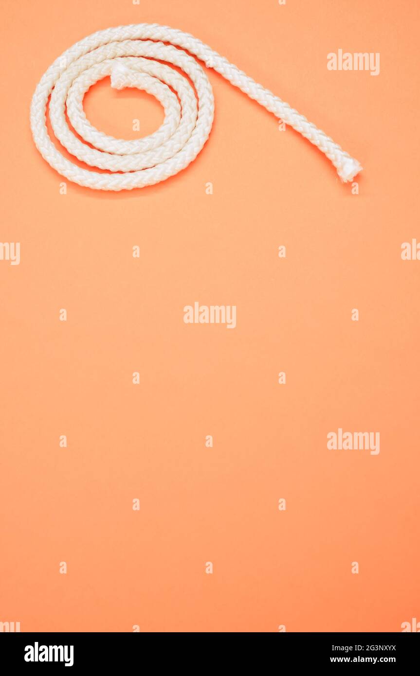 White spiral-shaped rope on peach background Stock Photo - Alamy