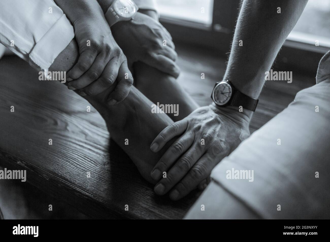 Man holds his girls feet on window sill Stock Photo - Alamy