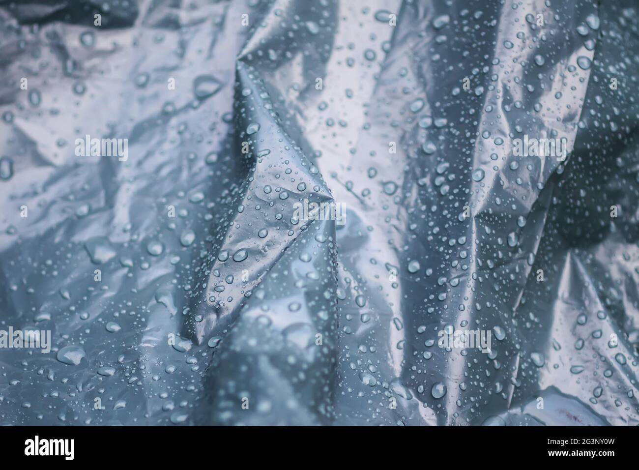 Wet crumpled plastic cover surface with drops of rain Stock Photo - Alamy