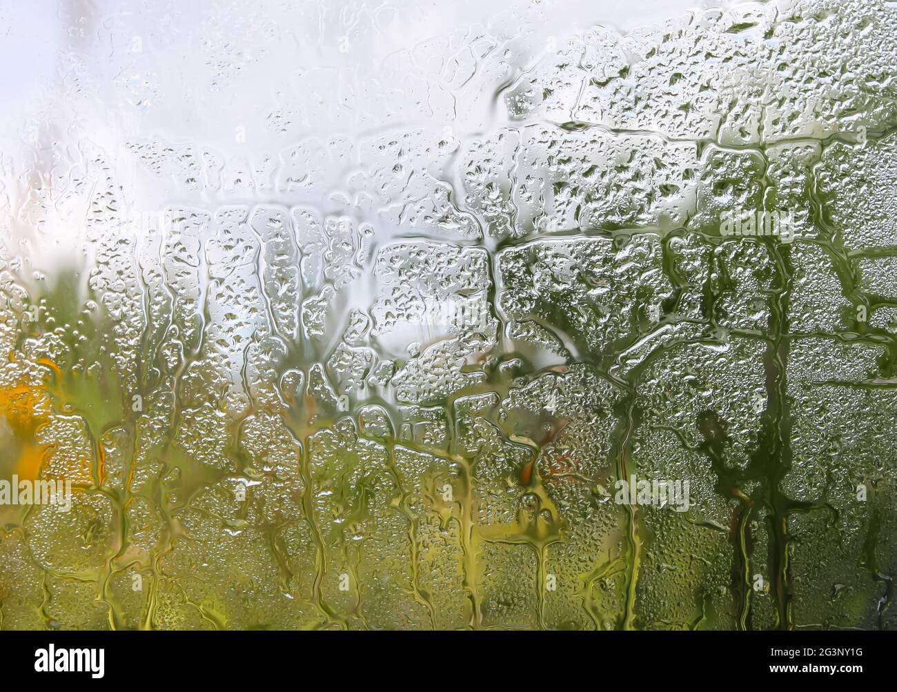 Wet glass with drops of rain on nature background Stock Photo - Alamy