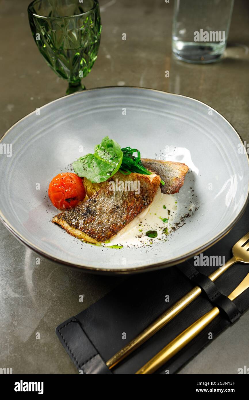 Dorada fillet with baked young cabbage and milk sauce Stock Photo - Alamy