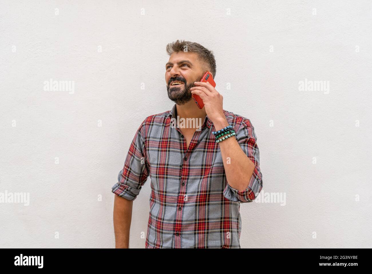 Man talking on smartphone on white background Stock Photo - Alamy