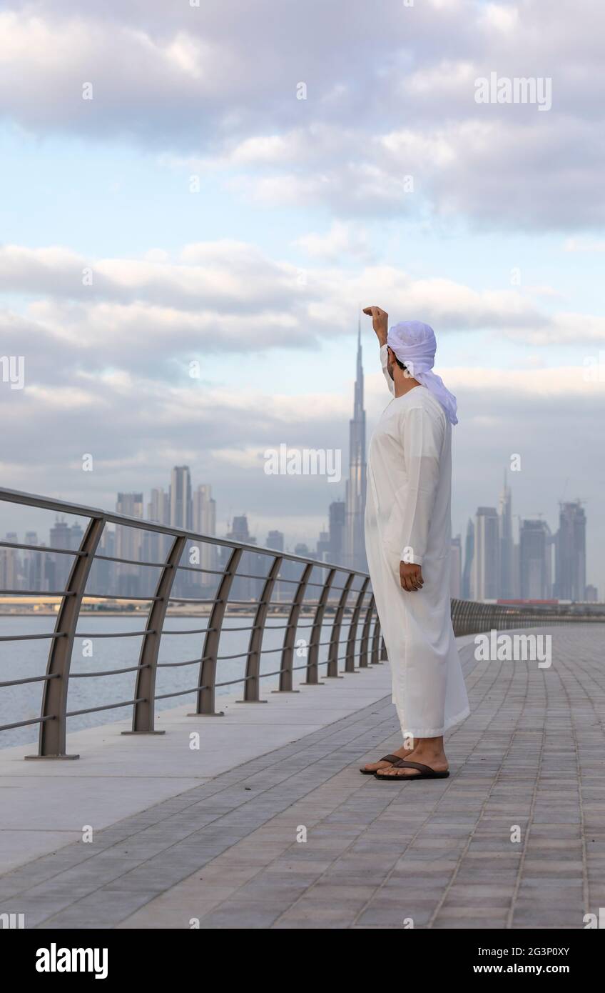emirati Man at Al Jaddaf waterfront in Dubai with Burj Khalifa at the ...