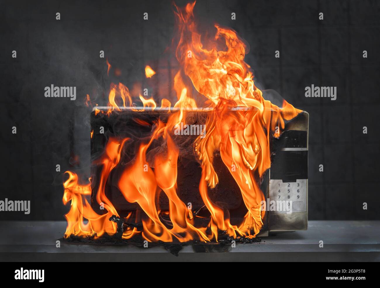 Microwave oven white, in fire front view, electrical appliances caught ...