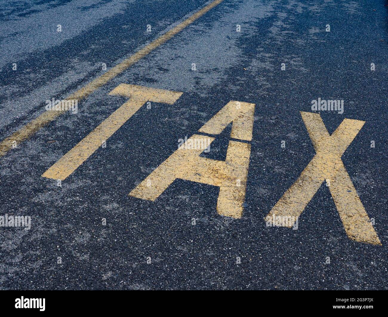 Tax sign on tarmac Stock Photo - Alamy