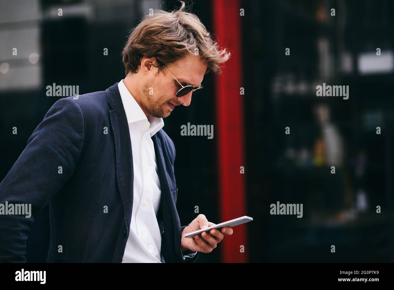 Stylish Young Male Boss Checks His Mobile Phone While Standing In The ...