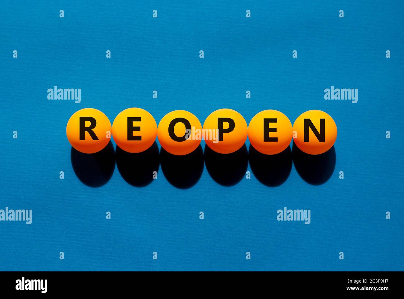 Reopen and bonus symbol. The concept word 'reopen' on orange table ...