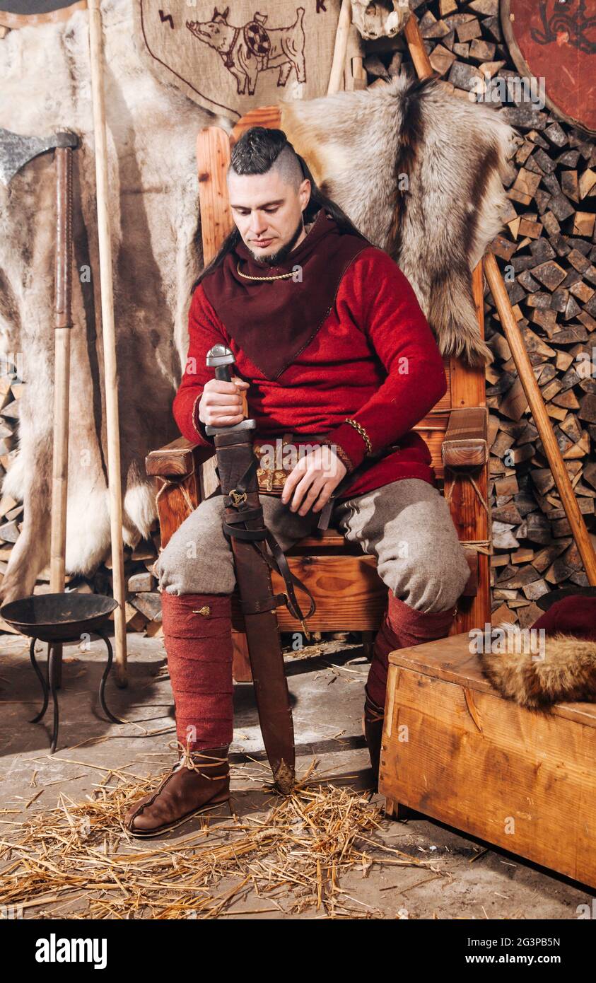 Viking posing against the background of the ancient interior of the ...