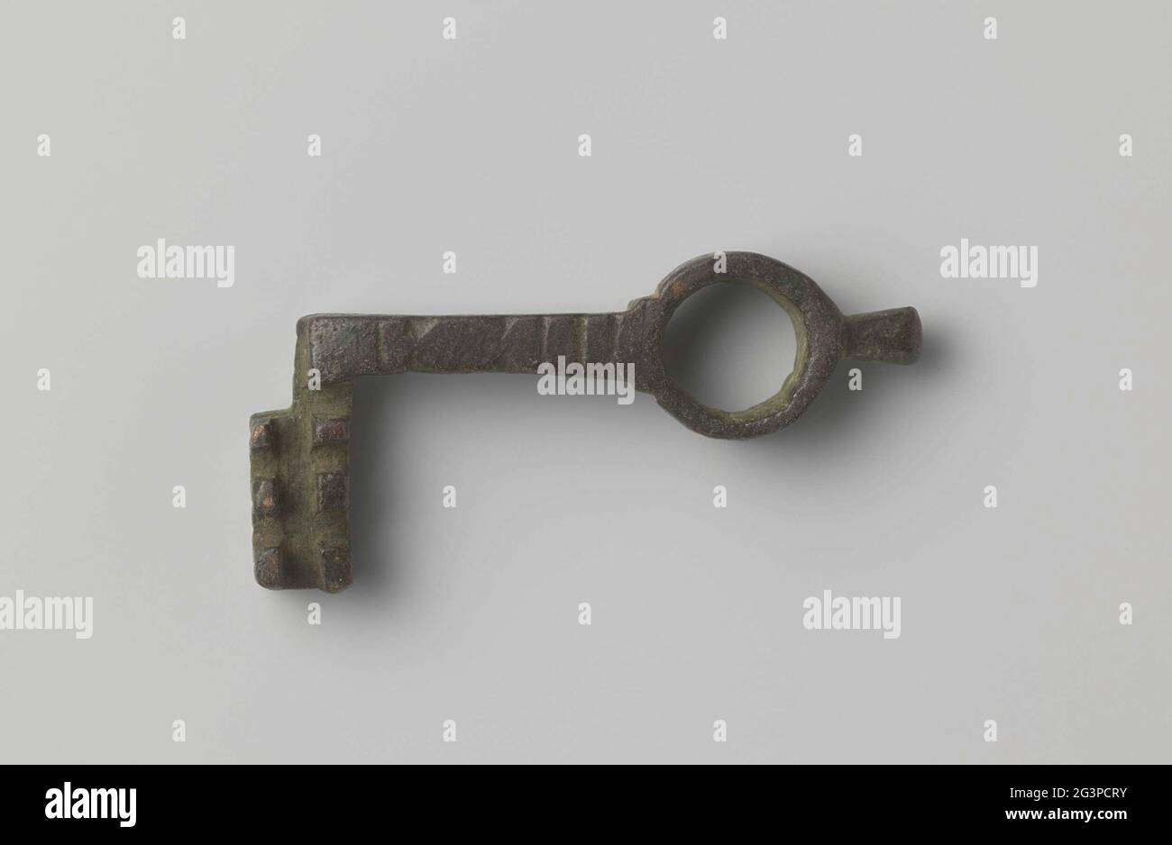 Key from bronze. Bronze key with cross beard, round ring, on which a ...