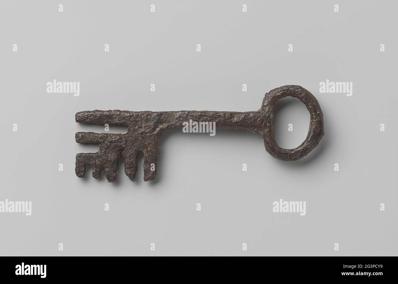 Key. Key with deeply incised square beard, four-sided shaft and oval ...