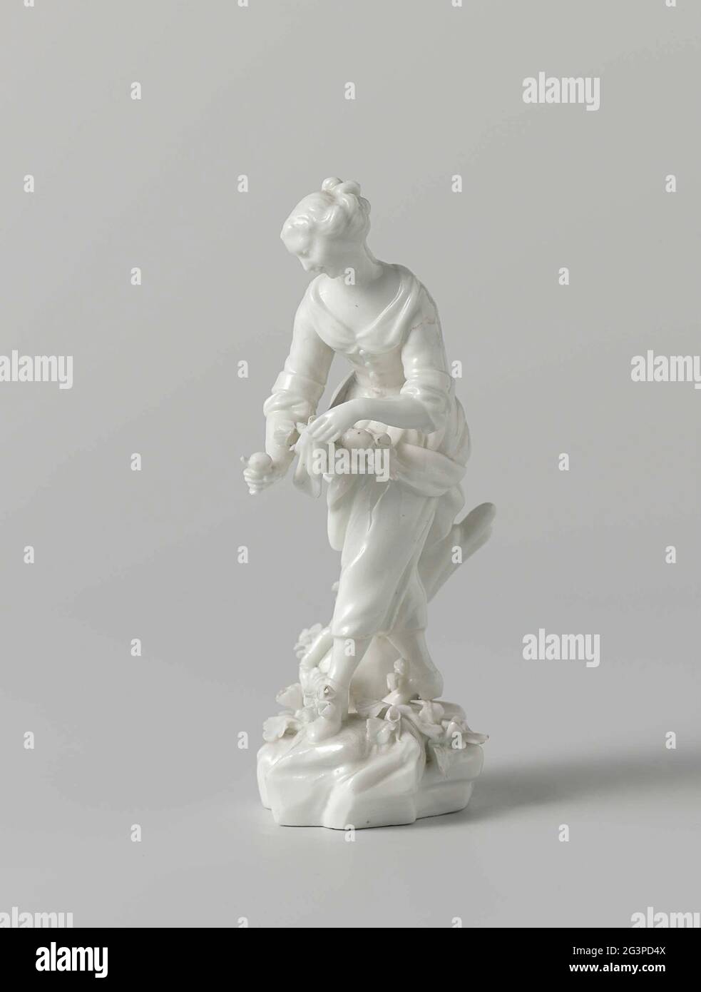 Girl with fruits. Girl with fruits of unpainted porcelain, standing on ...