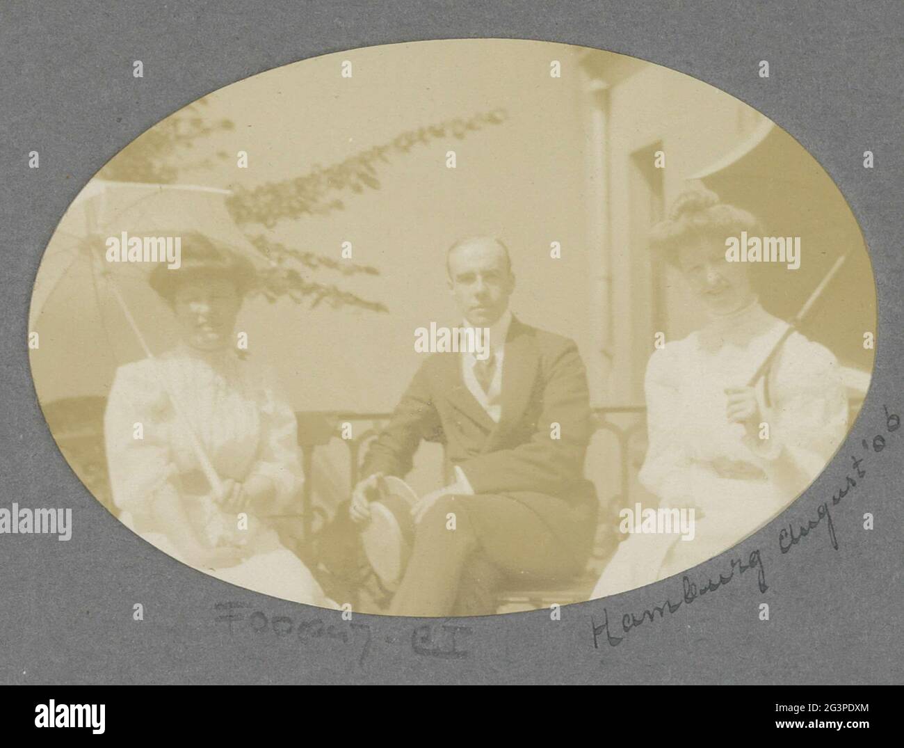 Group portrait of two women and a man in Hamburg. Part of travel album ...