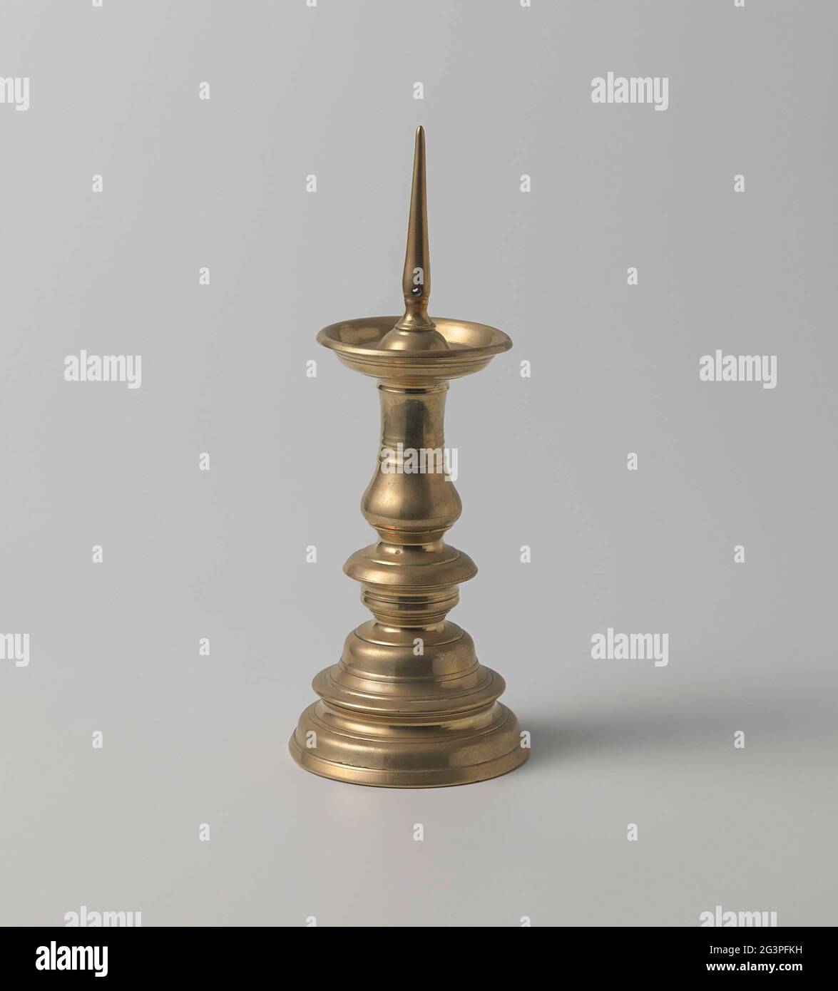 Candlestick of brass. Foot, trunk and fat catcher are poured into one ...