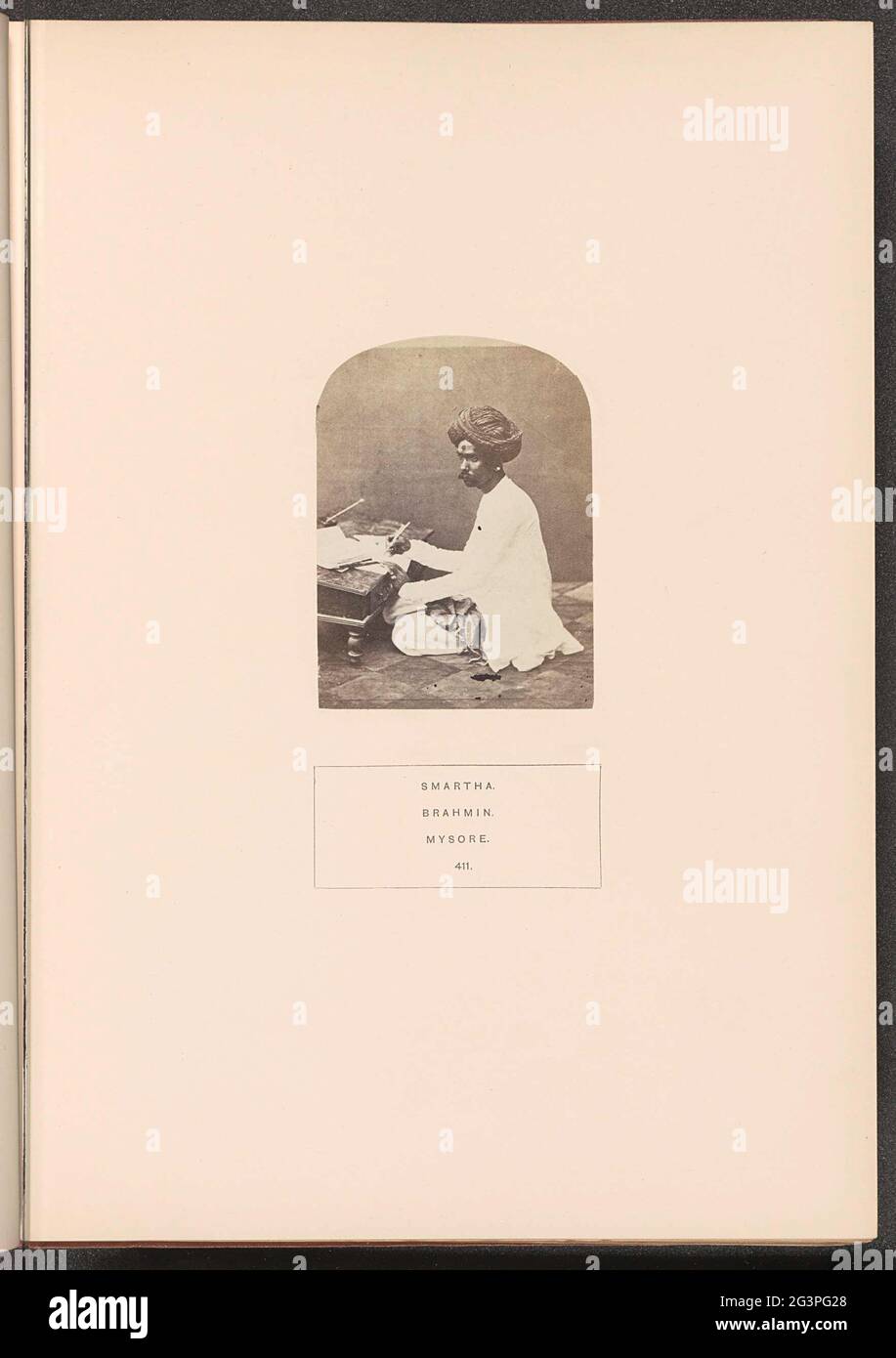 Portrait of an unknown smarta from mysore behind a low writing table ...