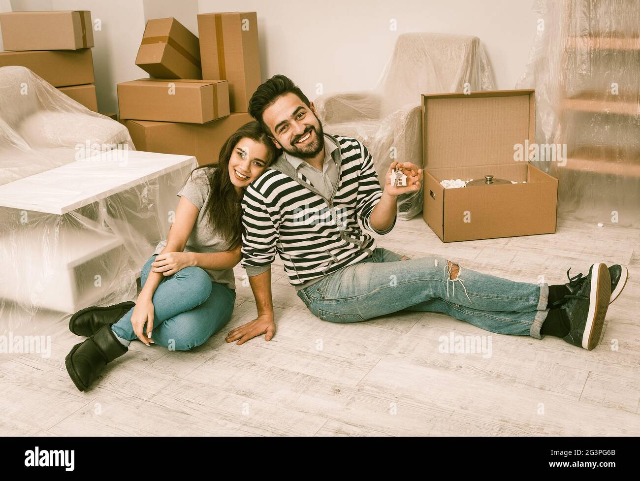 Man and woman smiling preparing to relocate to a new home Stock Photo ...