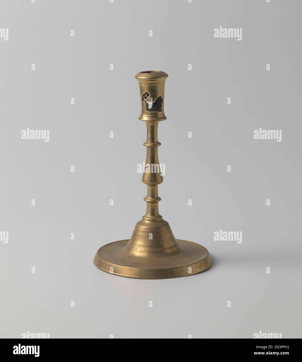 Candlestick of brass. The object is composed of two parts: the foot and ...