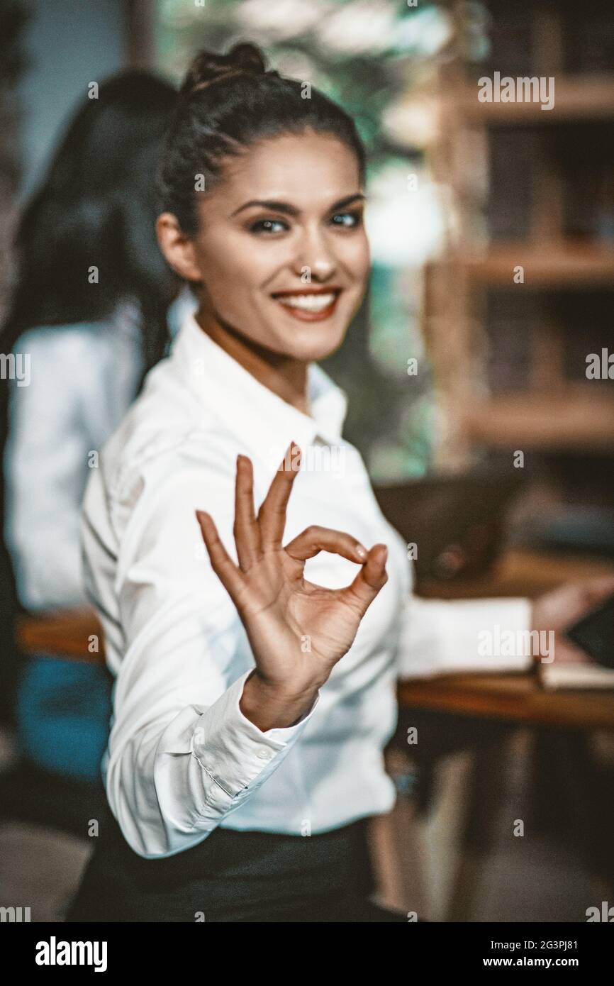 Female Office Manager Shows Ok Sign Stock Photo - Alamy