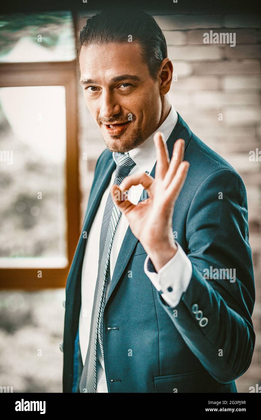 Smiling Professional businessman Showing Ok Sign Stock Photo - Alamy