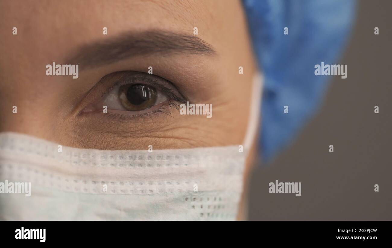 Female doctor's eye and Protective mask, Close up Stock Photo - Alamy