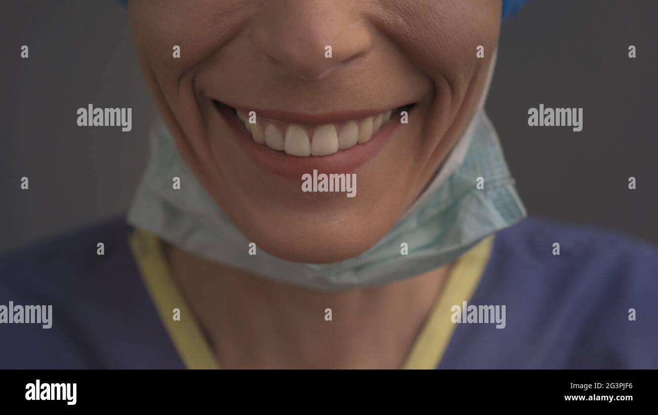 Doctor Toothy Smiles Taking Off Protective Mask, Close Up Stock Photo ...