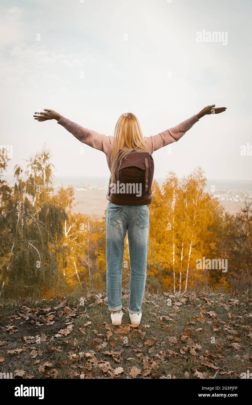Woman arms raised rear view sky hi-res stock photography and images - Alamy
