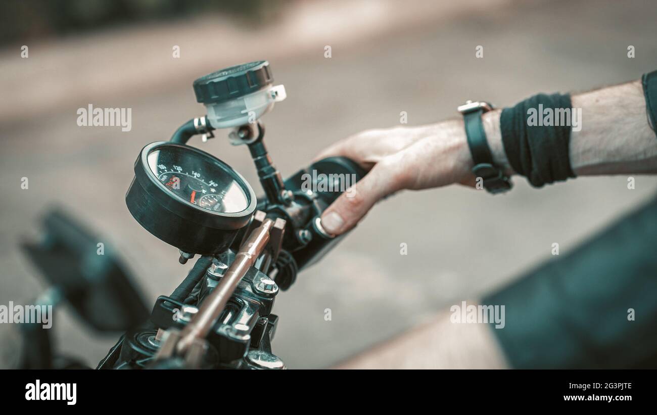 Male Hand Holding Wheel Of Motorbike Outdoors Stock Photo - Alamy
