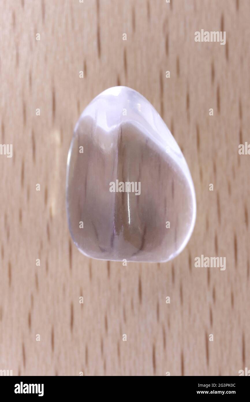 Clear quartz jewel texture on light varnished wood background. Macro ...