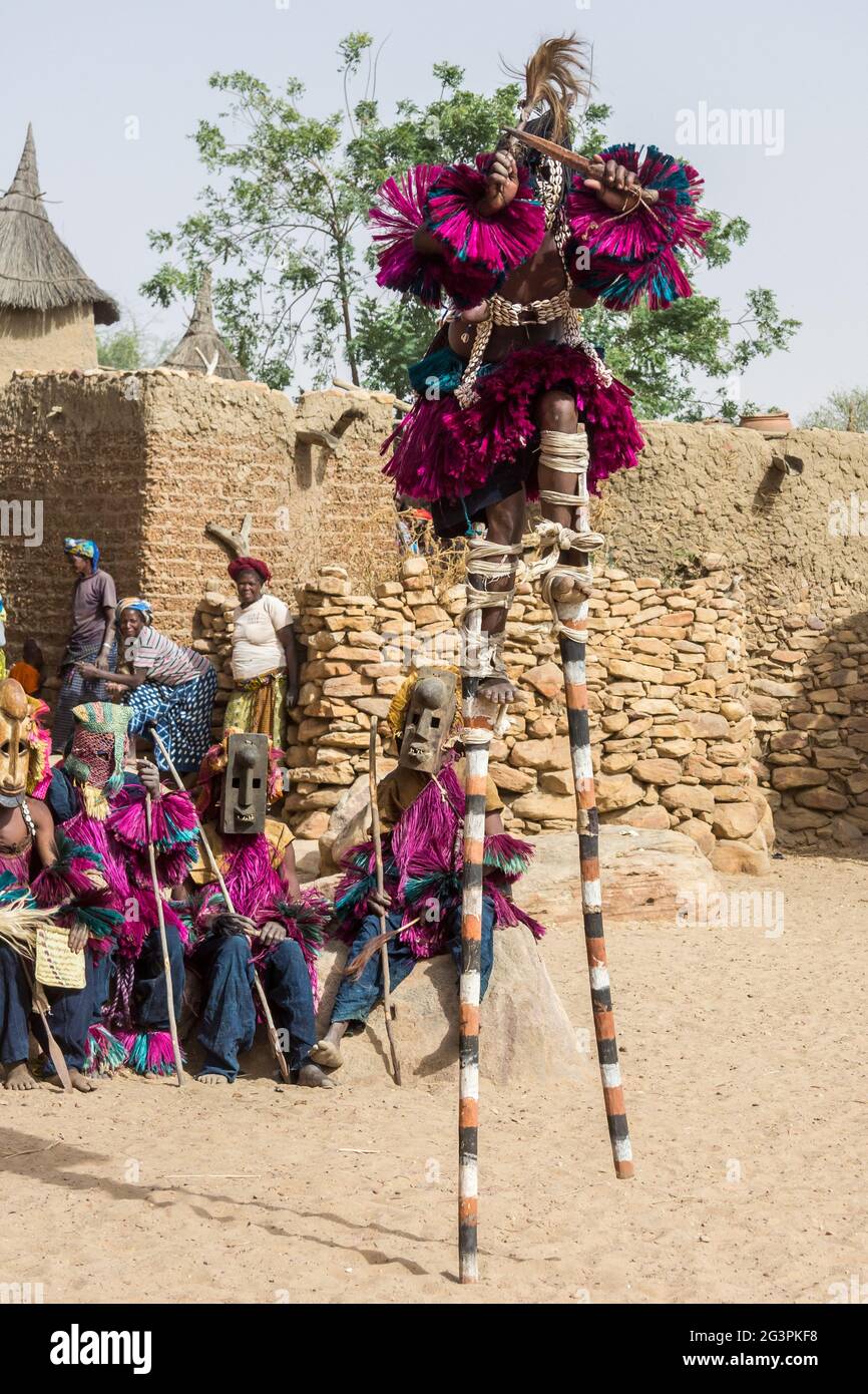 Dogon dancers performing the Dama ritual dance wearing Kanaga masks ...