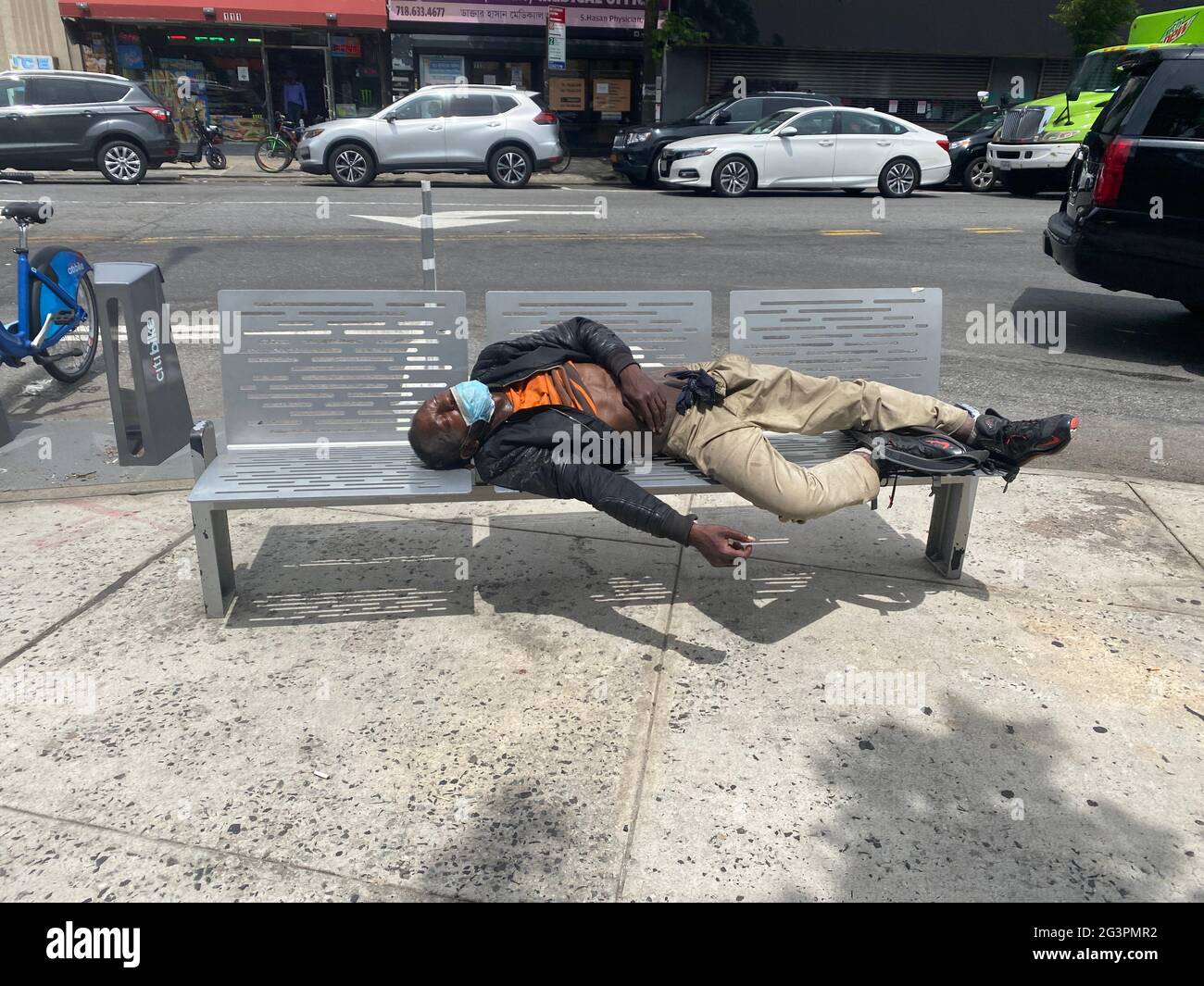 Homeless man sleeps on a bench along Church Avenue in the Kensington ...