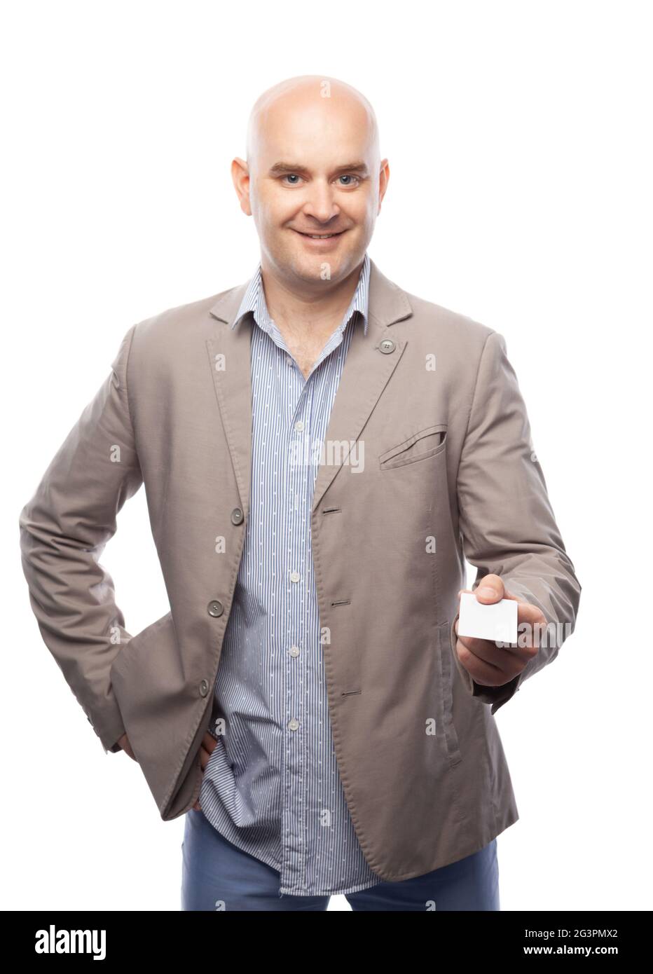 A bald man in a beige suit shows a business card isolated on white ...
