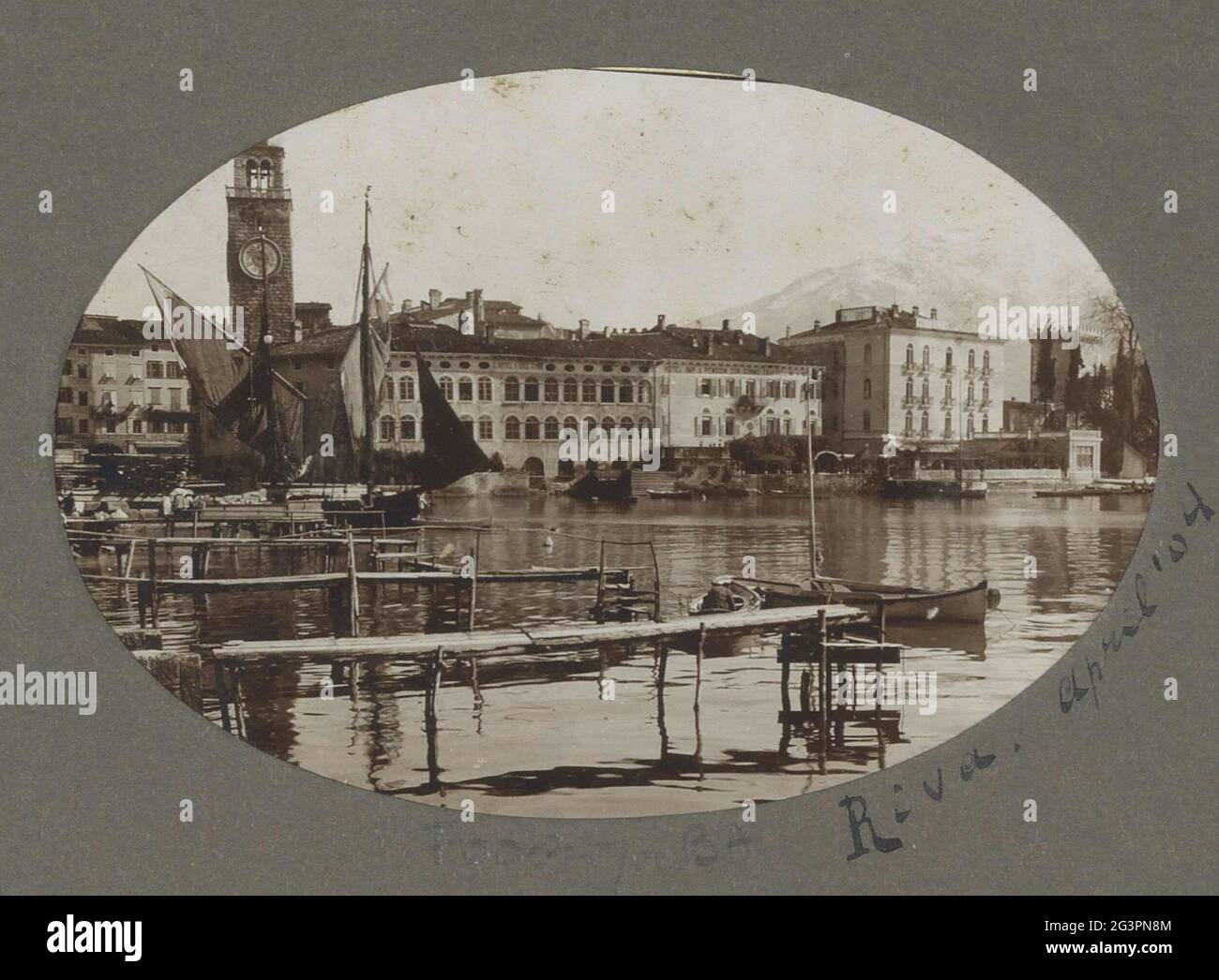 View of the port of Riva del Garda with bell tower, buildings and ...