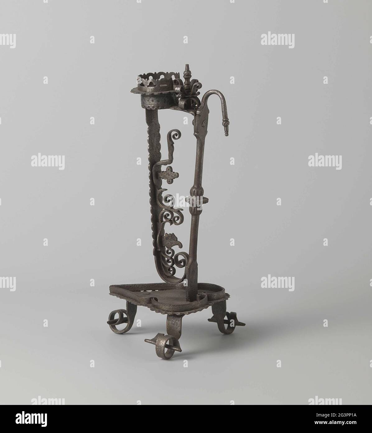 Candlestick with spring mechanism. Candlestick of wrought iron on three ...