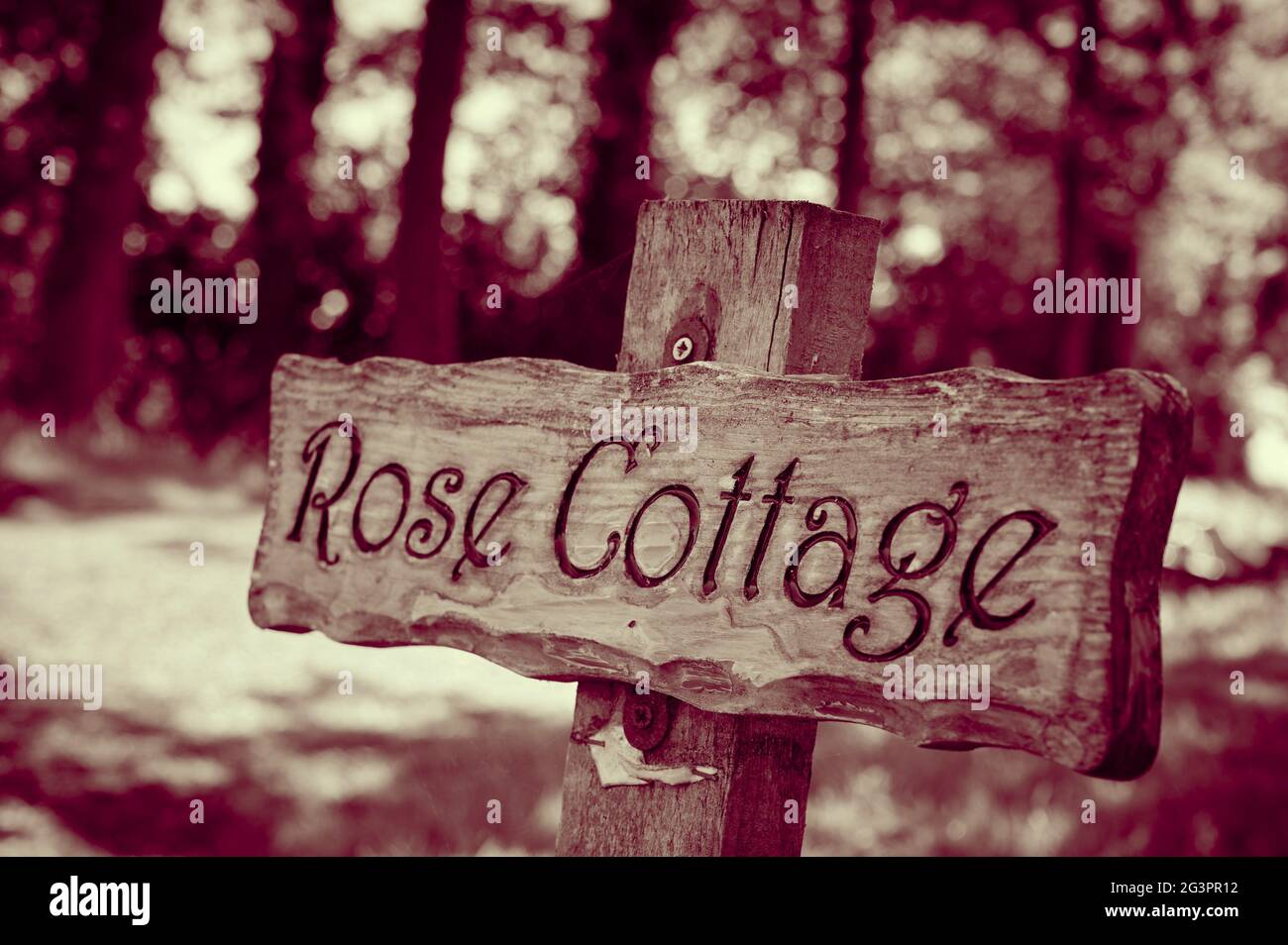Old wooden sign for Rose Cottage at end of driveway Stock Photo - Alamy