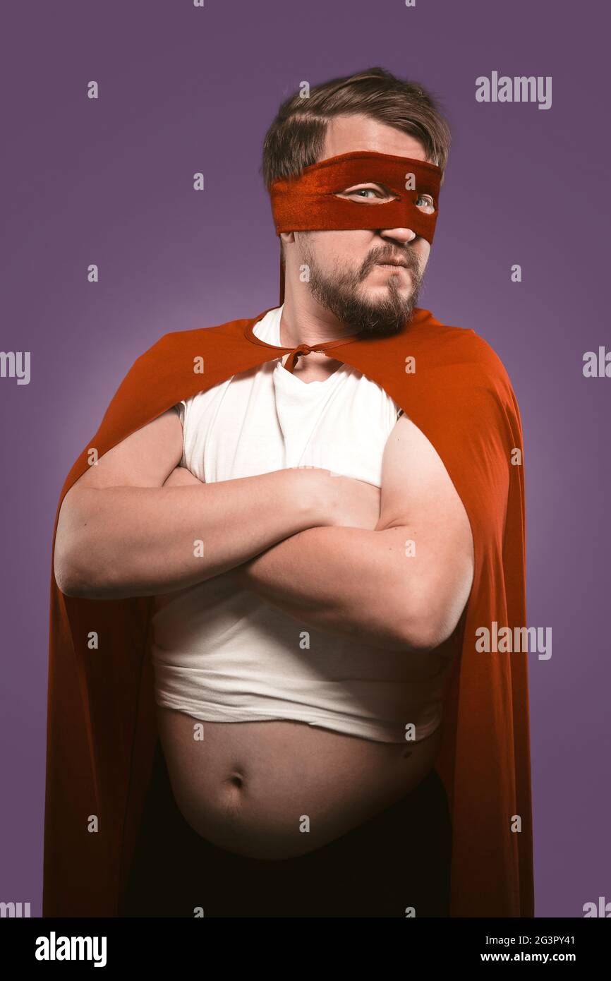 Super hero man with crossed arms and opened tummy looking at camera ...