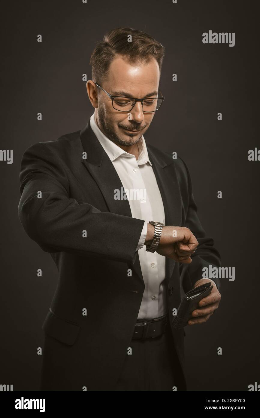 Checks time businessman in hi-res stock photography and images - Alamy