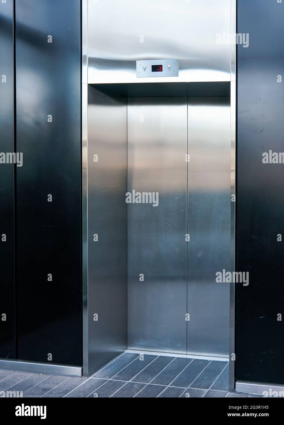 Modern steel elevator, door closed, floor showing -2 Stock Photo - Alamy