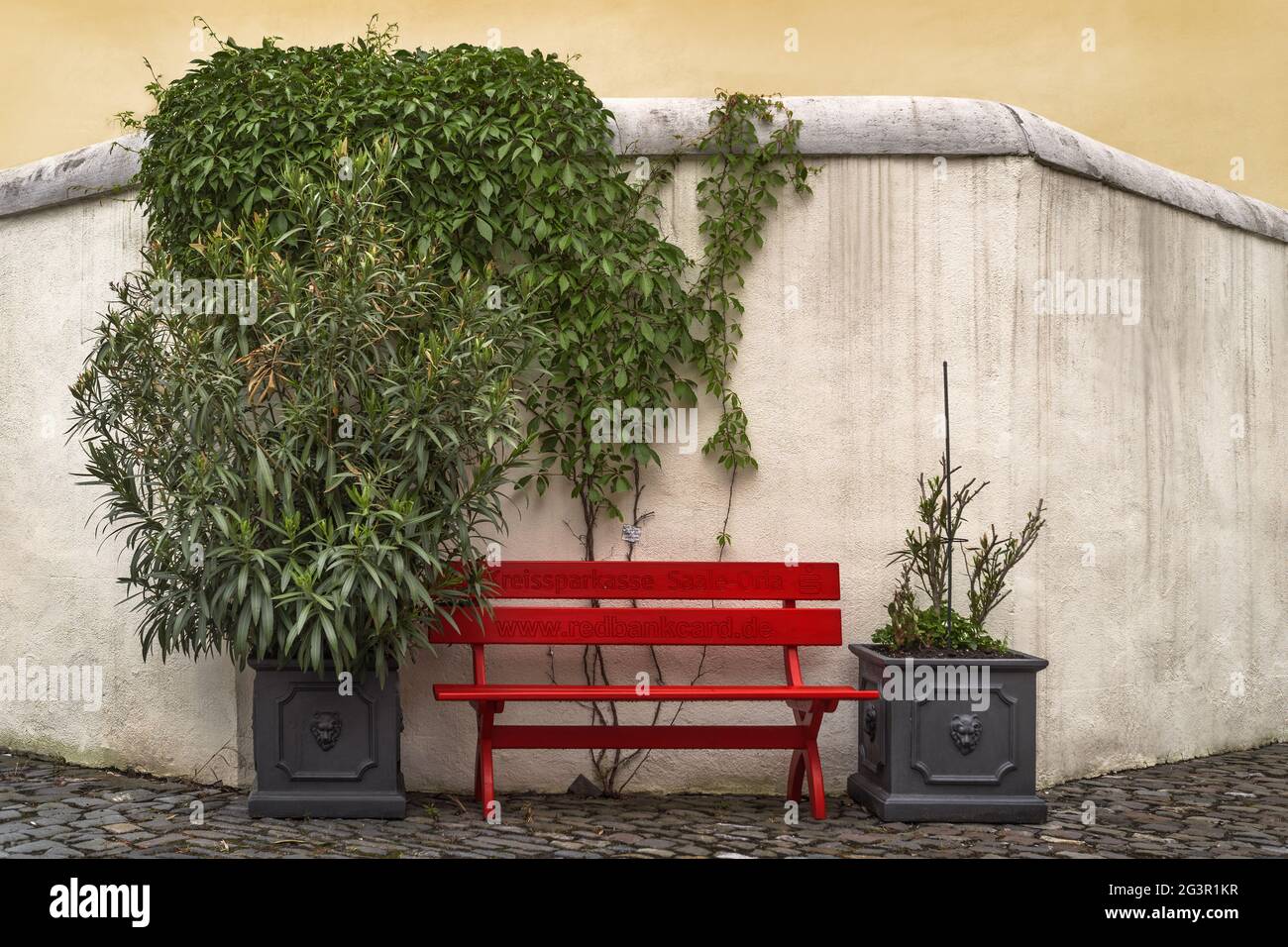 The red bench on the old wall Stock Photo - Alamy