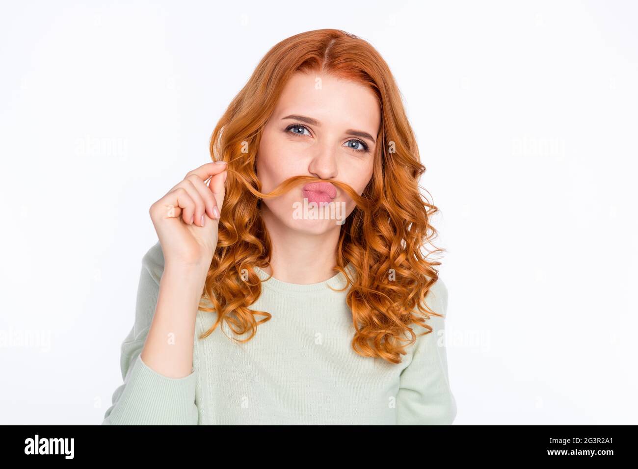 Photo portrait of red haired girl with fake mustache of hair pouted ...