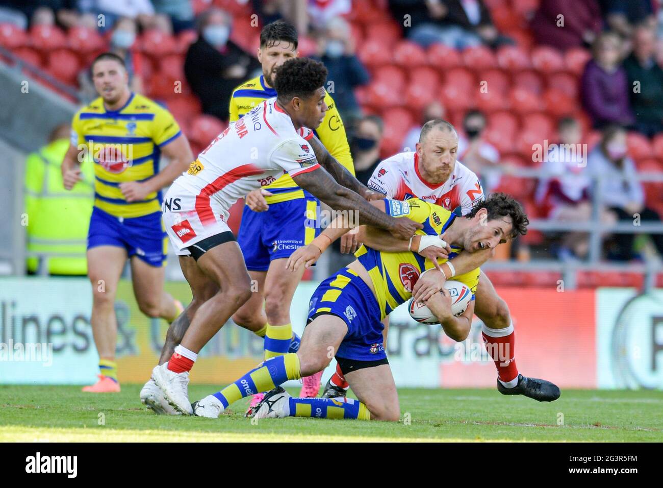 Stefan Ratchford (1) of Warrington Wolves is tackled by Kevin Naiqama ...