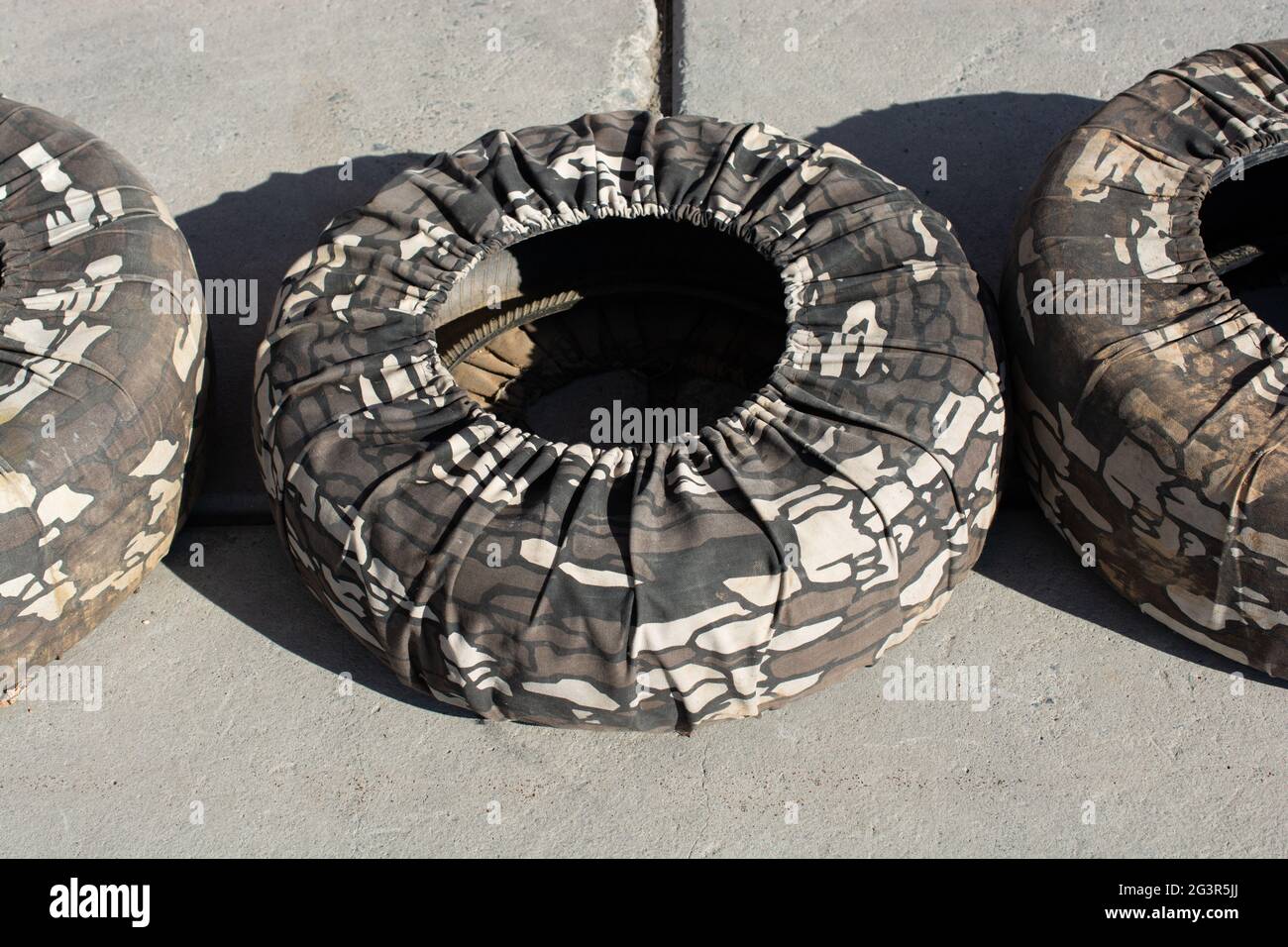 High angle shot of tires with military cover Stock Photo - Alamy