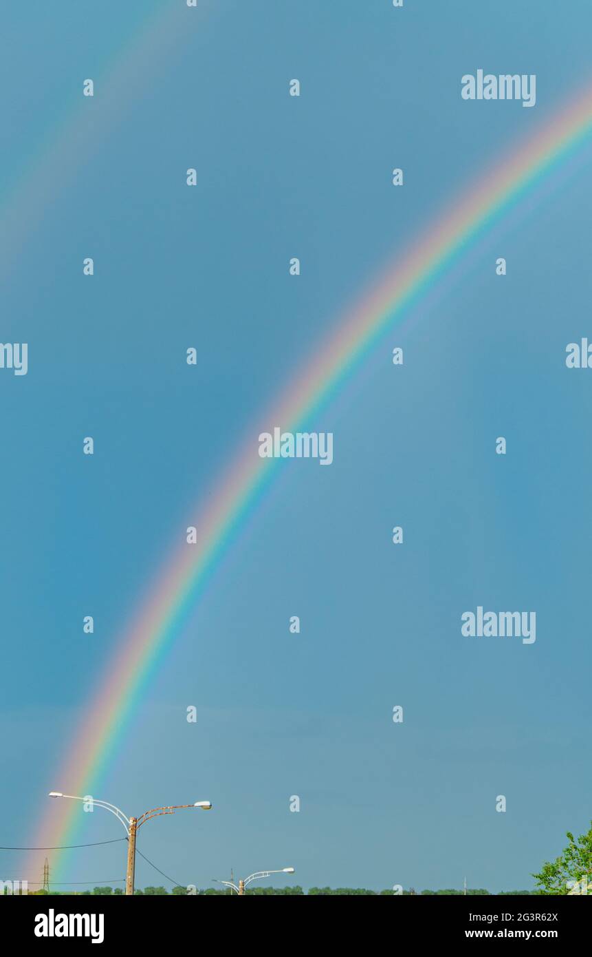 Vertical partial double rainbow on cloudy sky Stock Photo - Alamy