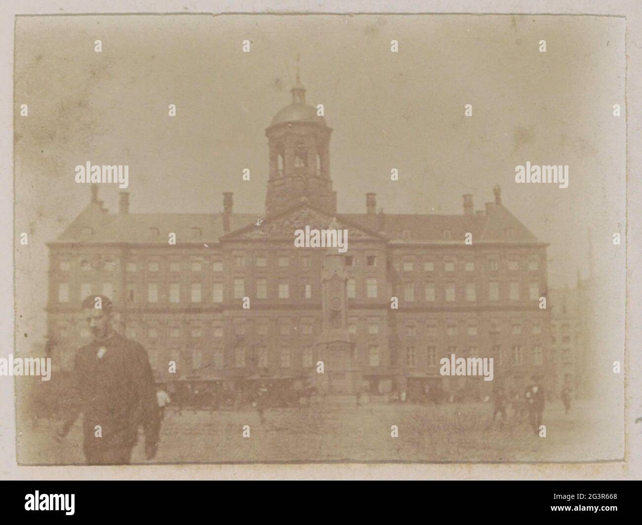 Royal palace on the dam with a man in the foreground. Part of photo ...