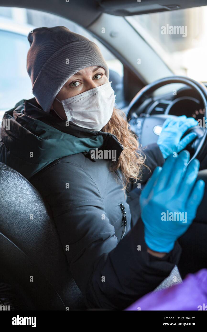 Crowdsourced taxi driver looking back at the passenger wearing a ...
