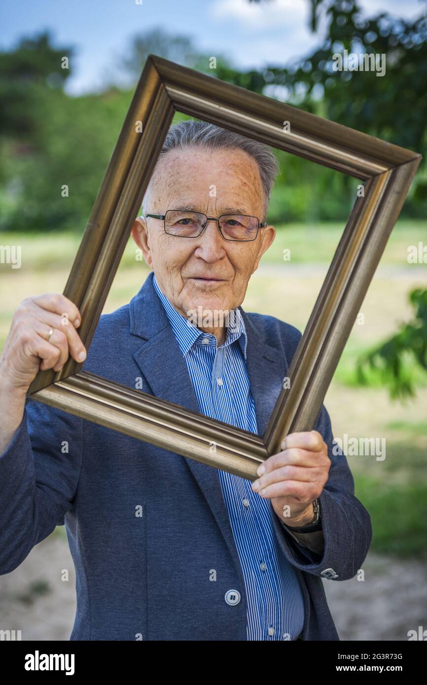 Pensioner in a picture frame Stock Photo - Alamy