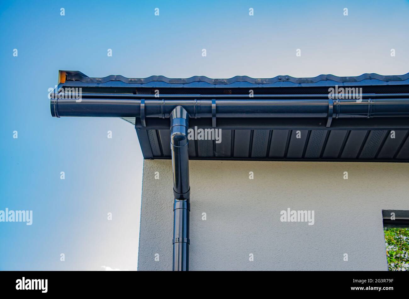 Gutter with downpipe on the roof a house Stock Photo - Alamy