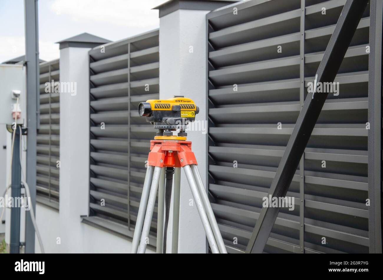Surveying measuring equipment level transit on tripod at construction ...