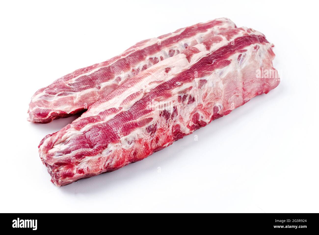 Raw pork spare loin ribs St Louis cut offered as closeup on white ...